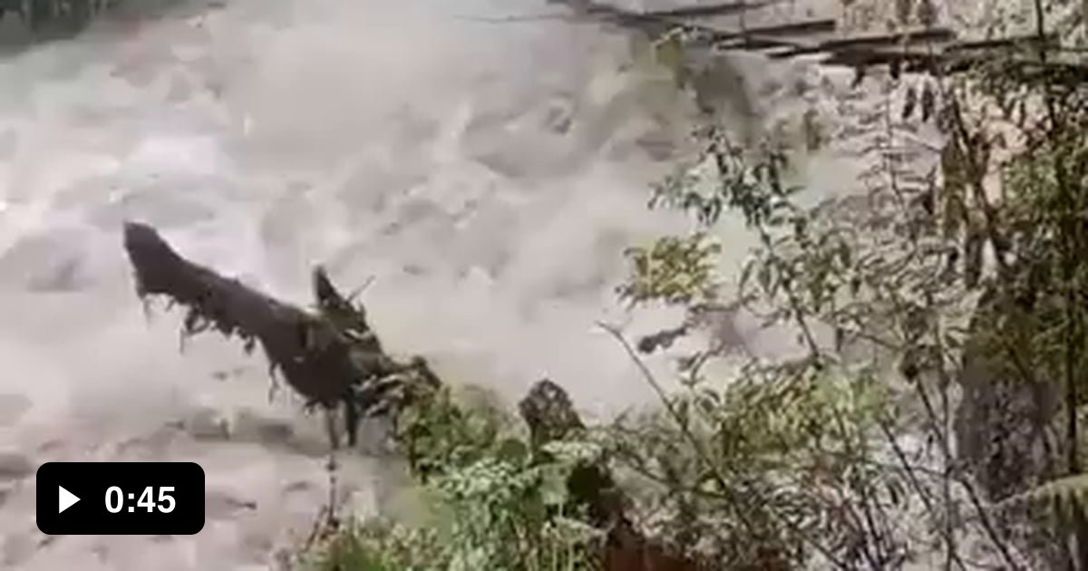 This man is risking his life crossing a bridge over a raging river. - 9GAG