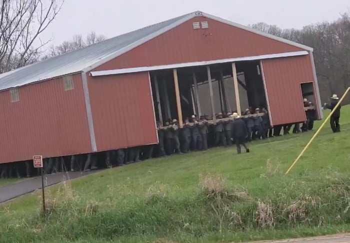 A whole crap load of Amish guys moving a barn. - 9GAG