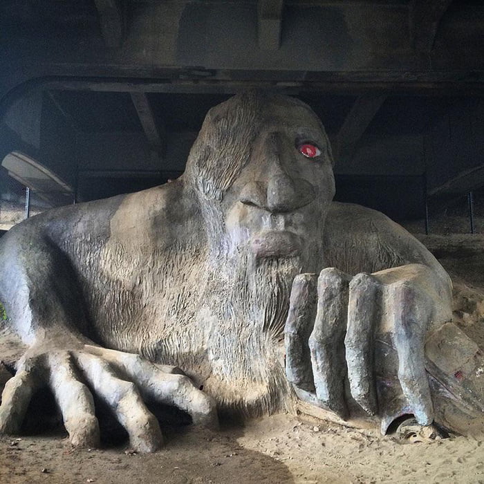 Statue of a troll holding a car under a bridge in Seattle - 9GAG