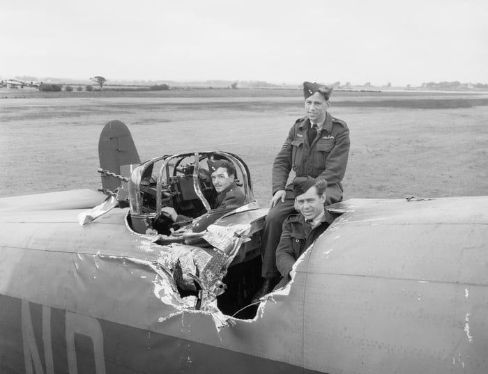 RAF Bomber Command aircrew show off the damage to their Halifax bomber ...