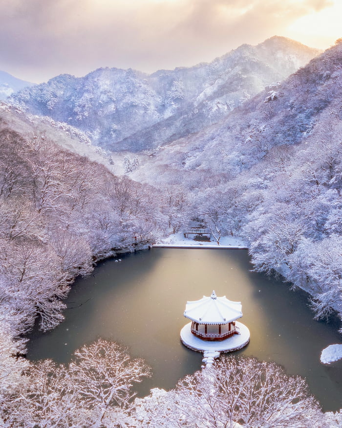 Small winter pond with a pavilion nestled in the Naejang Mountains ...