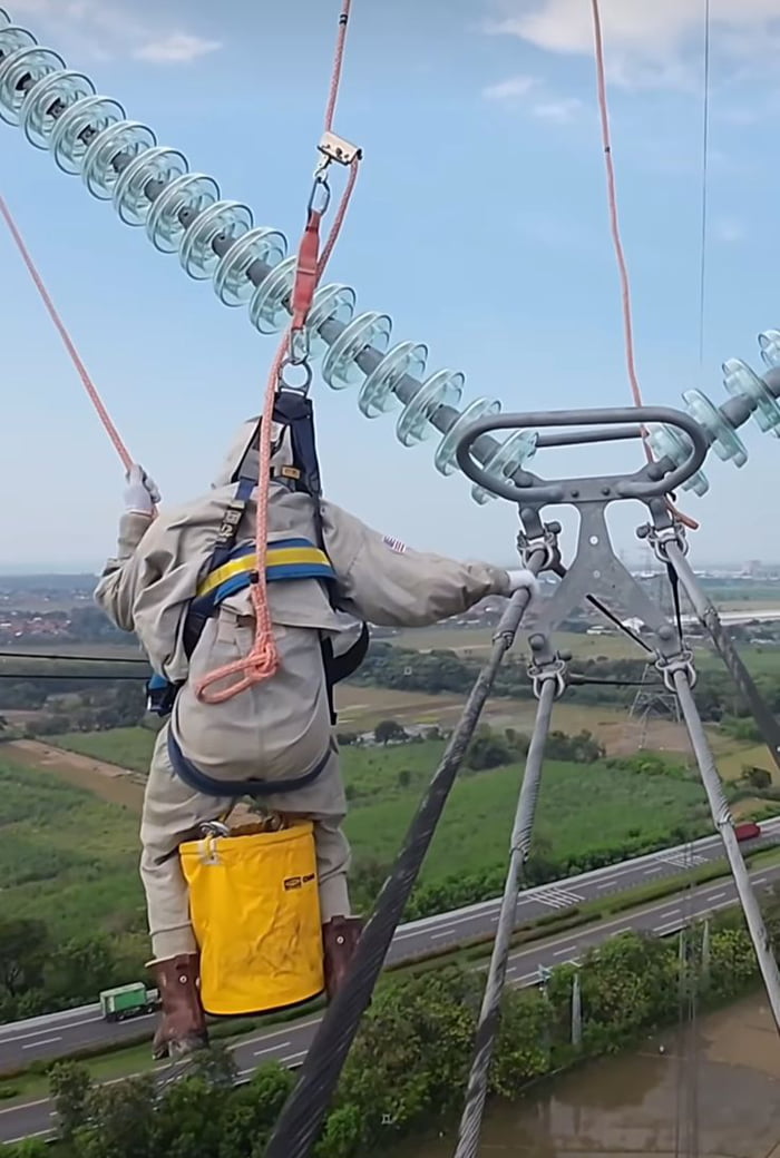 Working on active high voltage powerlies with a faraday suit. - 9GAG